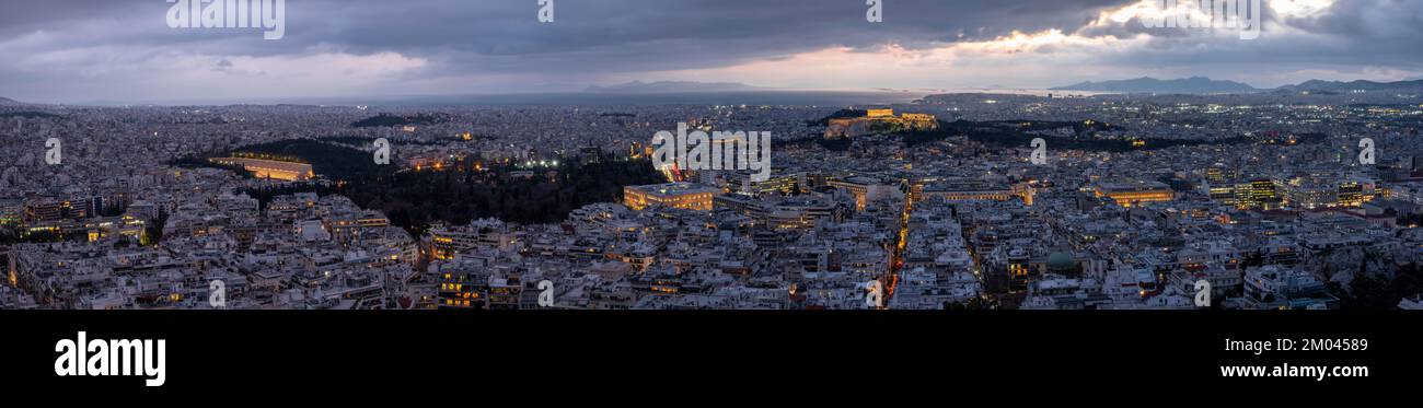 Panorama, view over the sea of houses of Athens, illuminated Parthenon ...