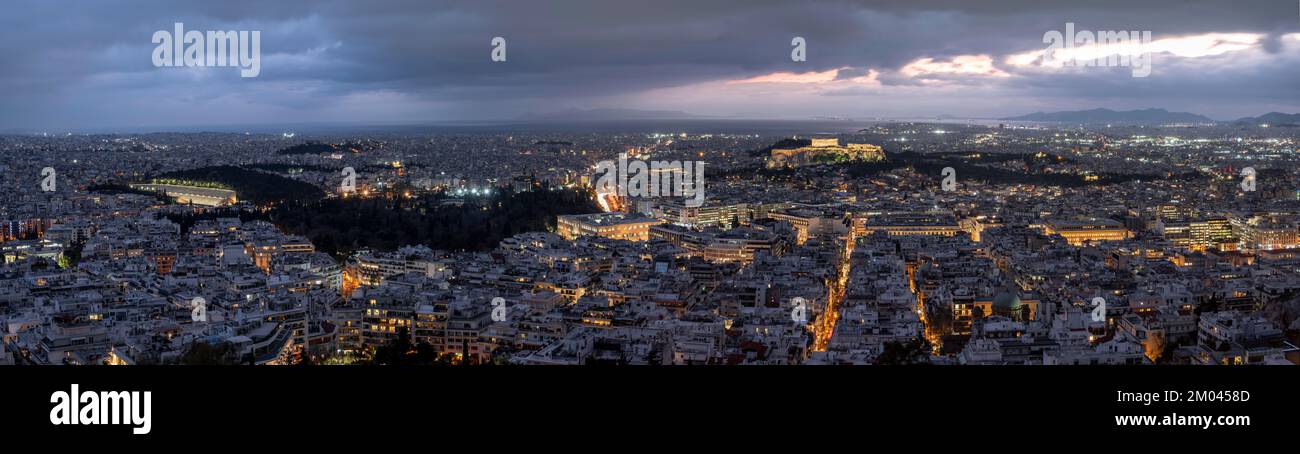 Panorama, view over the sea of houses of Athens, illuminated Parthenon ...