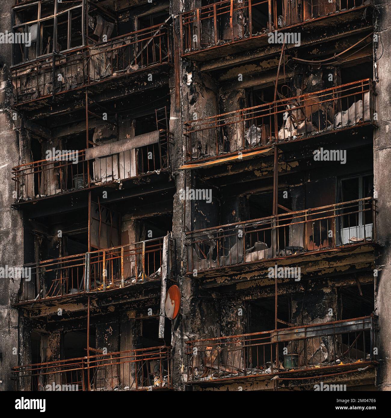 A burnt-out high-rise in the war zone. Damage to a residential building ...