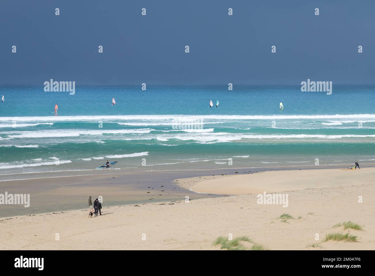 Dog walkers on the sandy Towans beach at the Hayle estuary (The Bluff ...