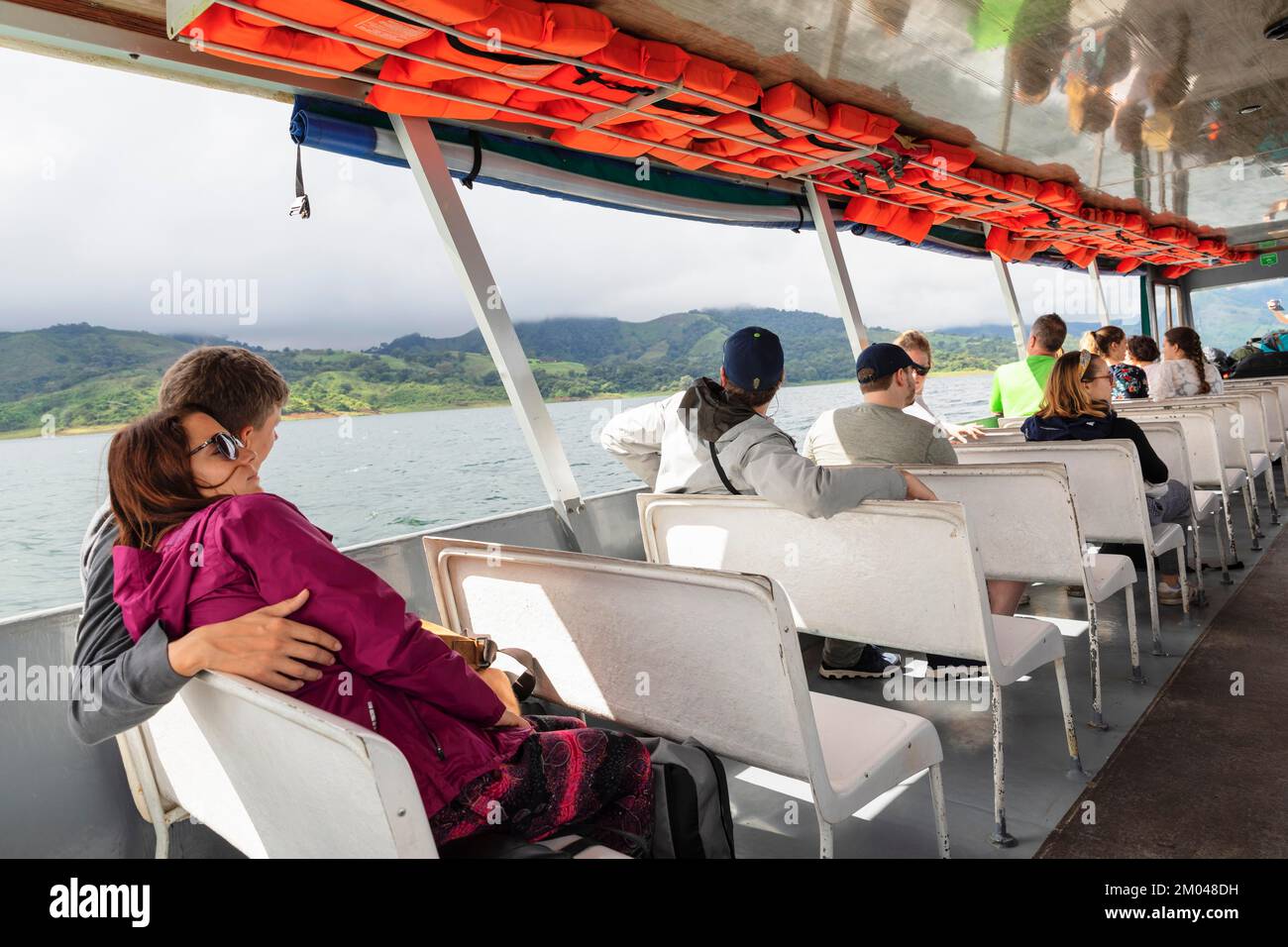 Tourists on a boat trip across Lake Laguna de Arenal, Arenal National ...