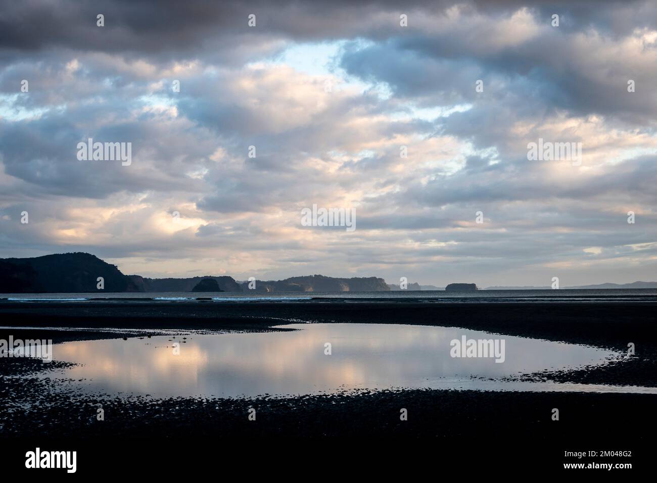 Clouds reflected in pool on beach at Orewa, Auckland, North Island, New ...