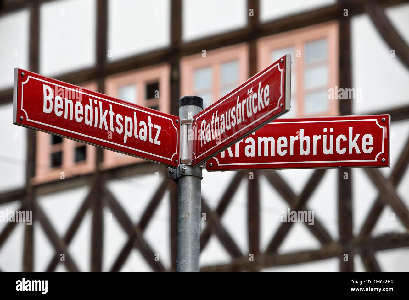 Red street signs in front of half-timbered houses in the old town ...