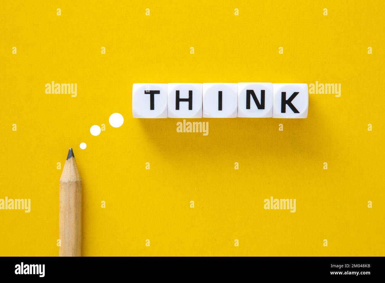 Pencil with the word think on yellow background. Thinking for creative ...