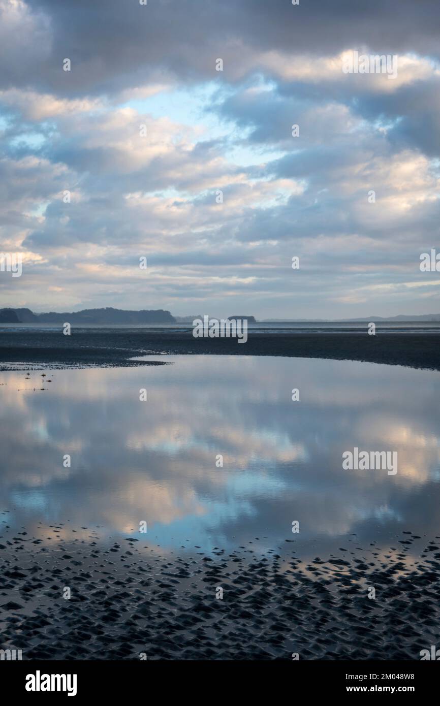 Clouds reflected in pool on beach at Orewa, Auckland, North Island, New ...