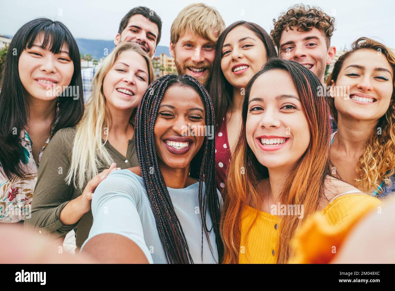 Happy multiracial friends looking at camera outdoor - Focus on african ...