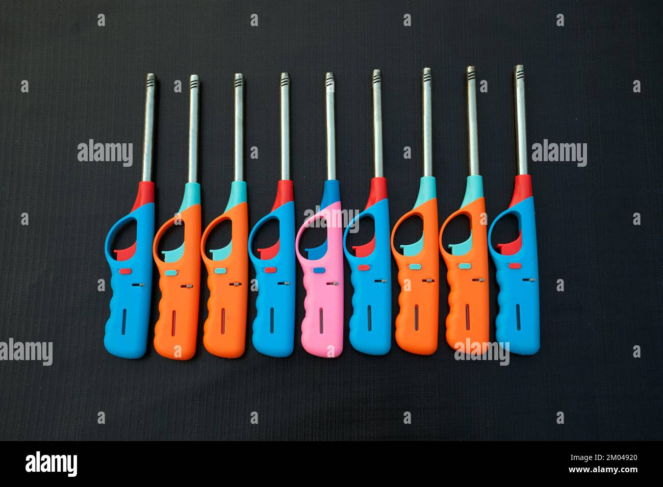 Group of colorful Gas lighter gun for gas-stove on a black background ...