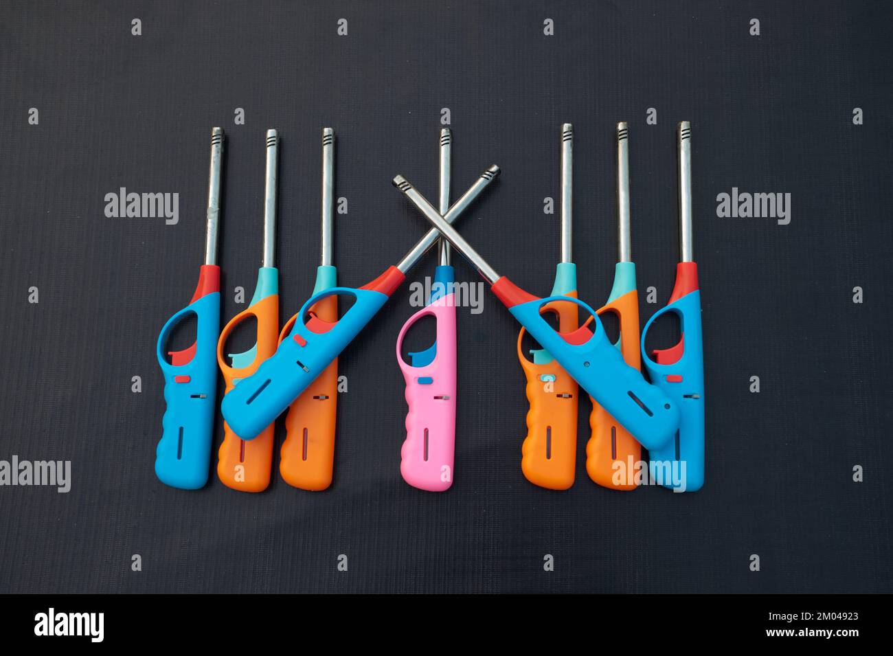 Group of colorful Gas lighter gun for gas-stove on a black background ...