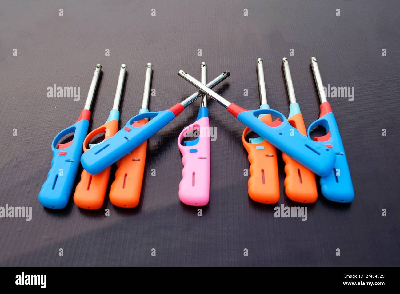 Group of colorful Gas lighter gun for gas-stove on a black background ...