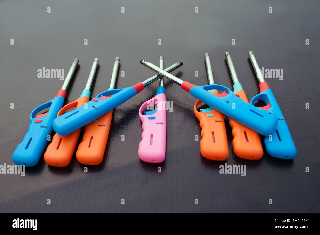 Group of colorful Gas lighter gun for gas-stove on a black background ...