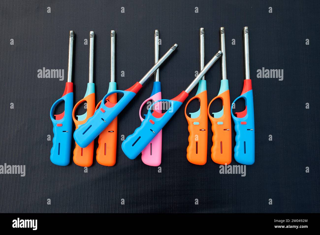 Group of colorful Gas lighter gun for gas-stove on a black background ...