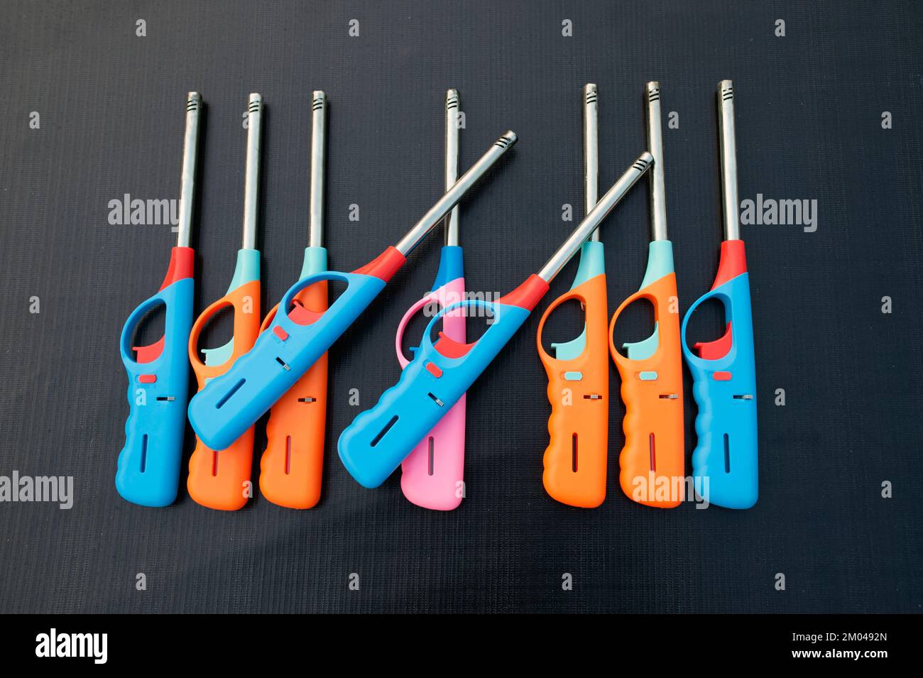 Group of colorful Gas lighter gun for gas-stove on a black background ...