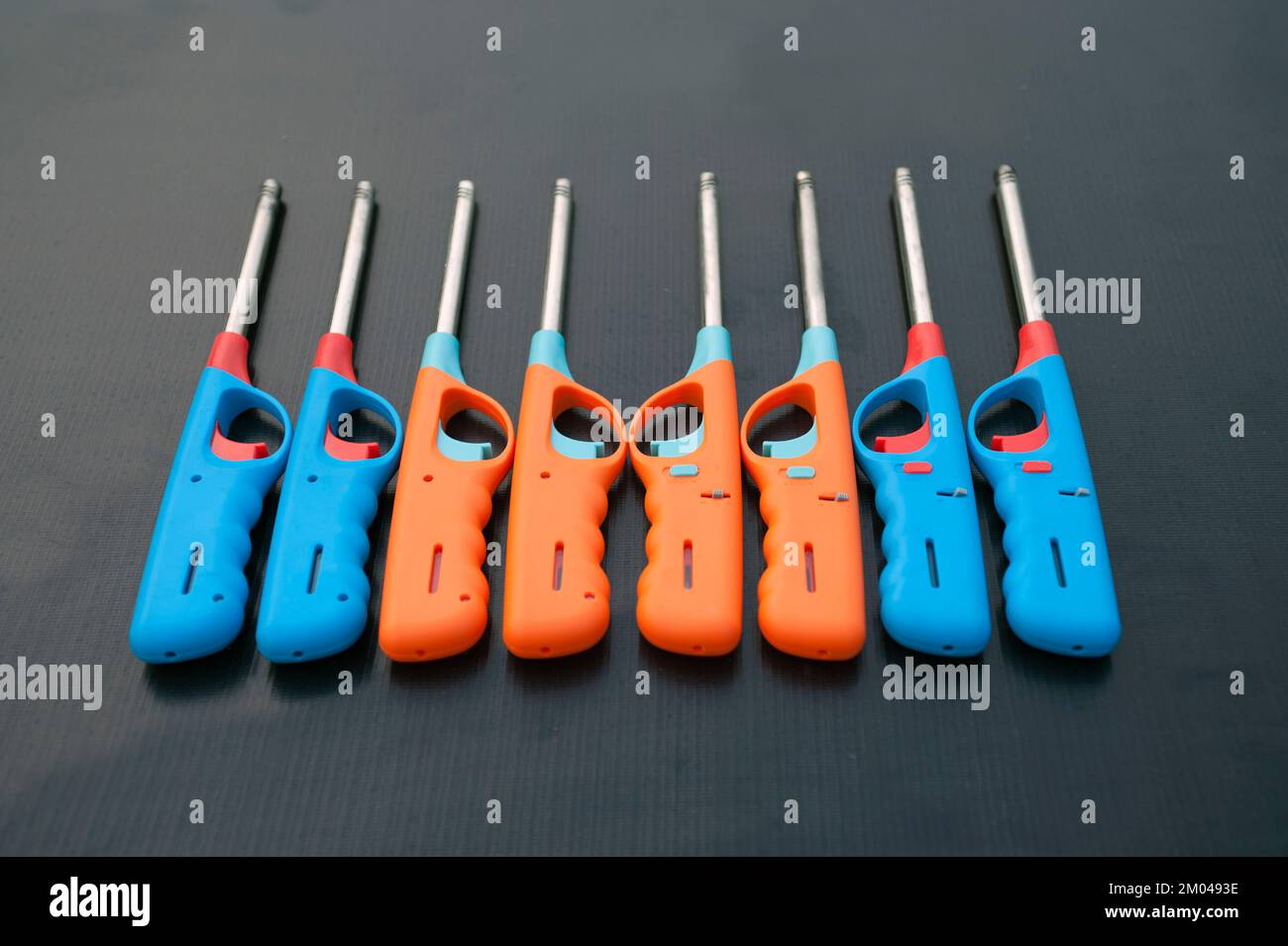 Group of colorful Gas lighter gun for gas-stove on a black background ...