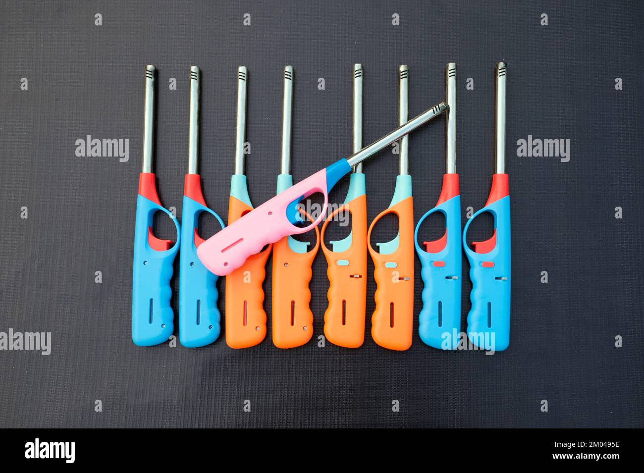 Group of colorful Gas lighter gun for gas-stove on a black background ...