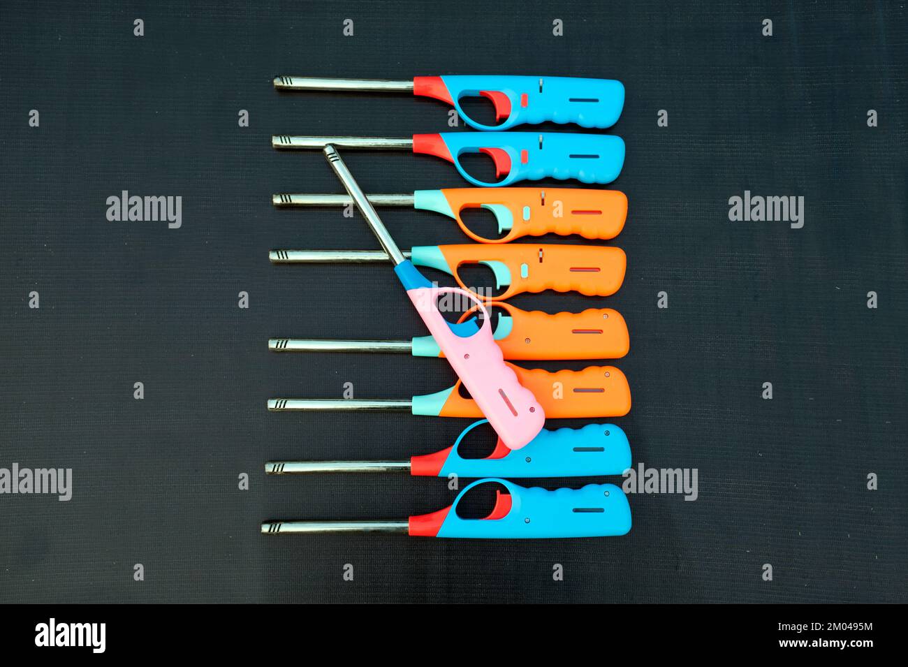 Group of colorful Gas lighter gun for gas-stove on a black background ...