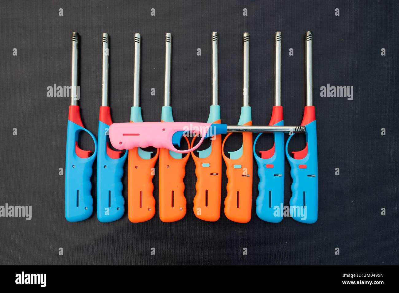 Group of colorful Gas lighter gun for gas-stove on a black background ...