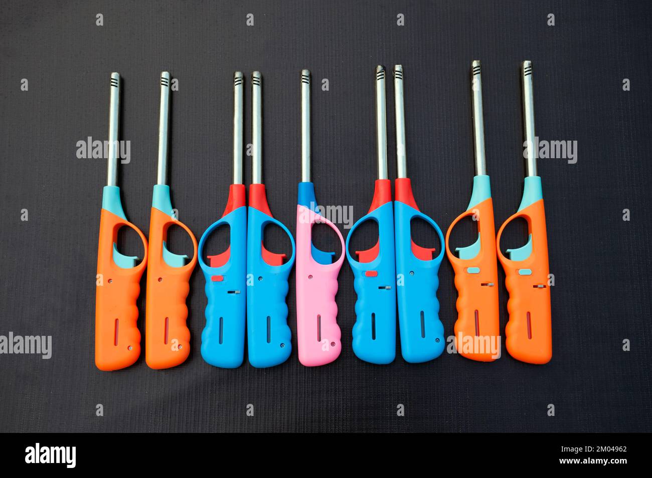 Group of colorful Gas lighter gun for gas-stove on a black background ...