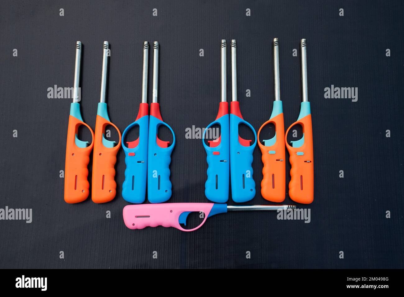 Group of colorful Gas lighter gun for gas-stove on a black background ...