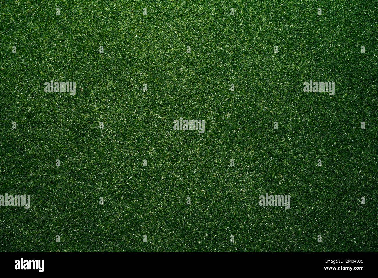 Top view of artificial sports grass texture of deep green. Simulating ...