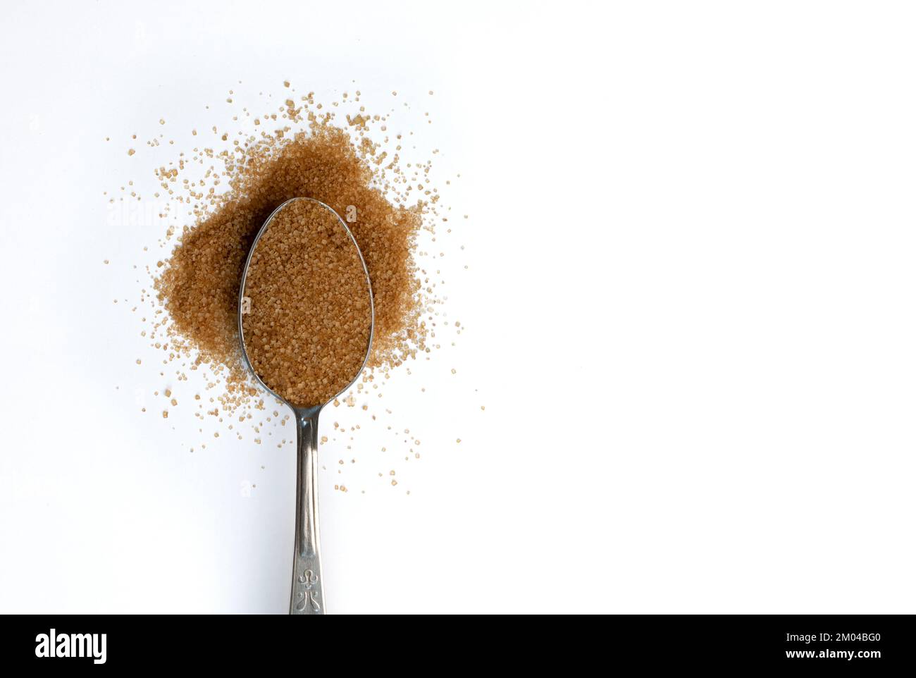 spoon with brown sugar on white background with copy space for text ...