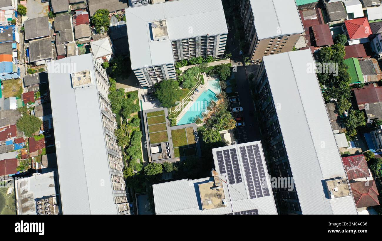 Top down of modern condominium with swimming pool and flat building in ...