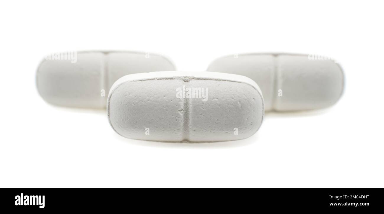 Medical pills with shadow on a white background close-up. Treatment ...