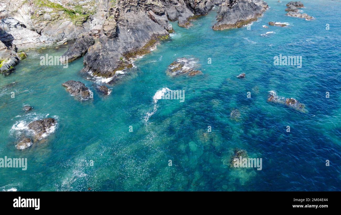 Steep cliffs on the southern coast of Ireland. Turquoise waters of the ...