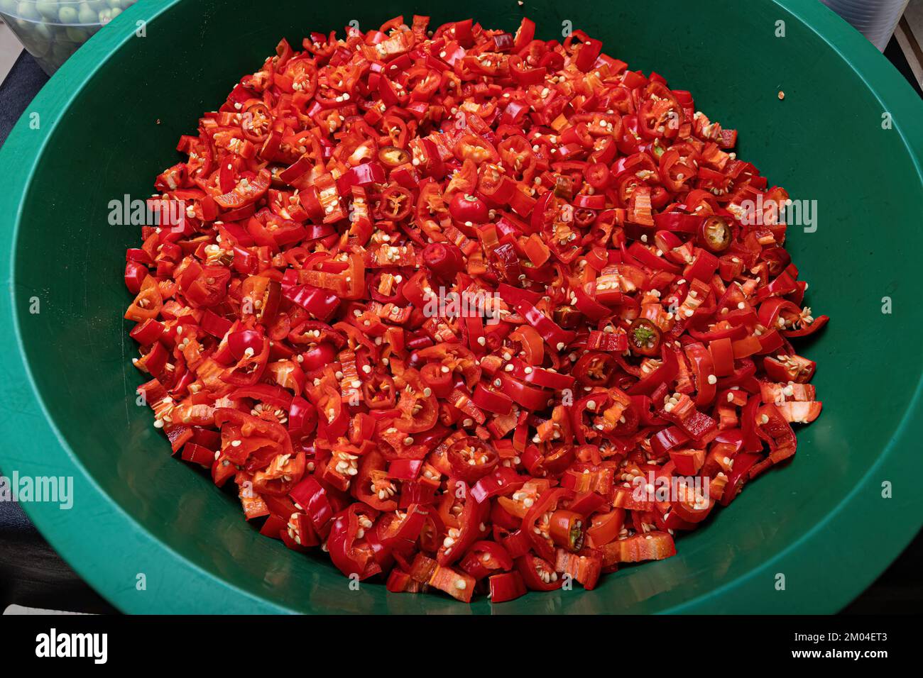 Many chopped big red peppers Stock Photo - Alamy