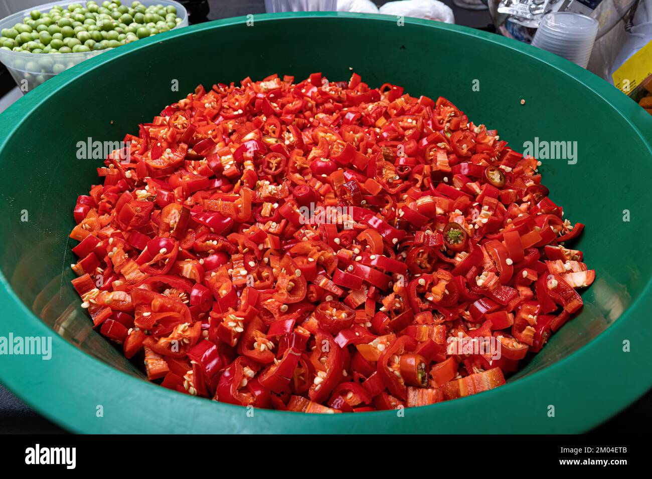 Many chopped big red peppers Stock Photo - Alamy