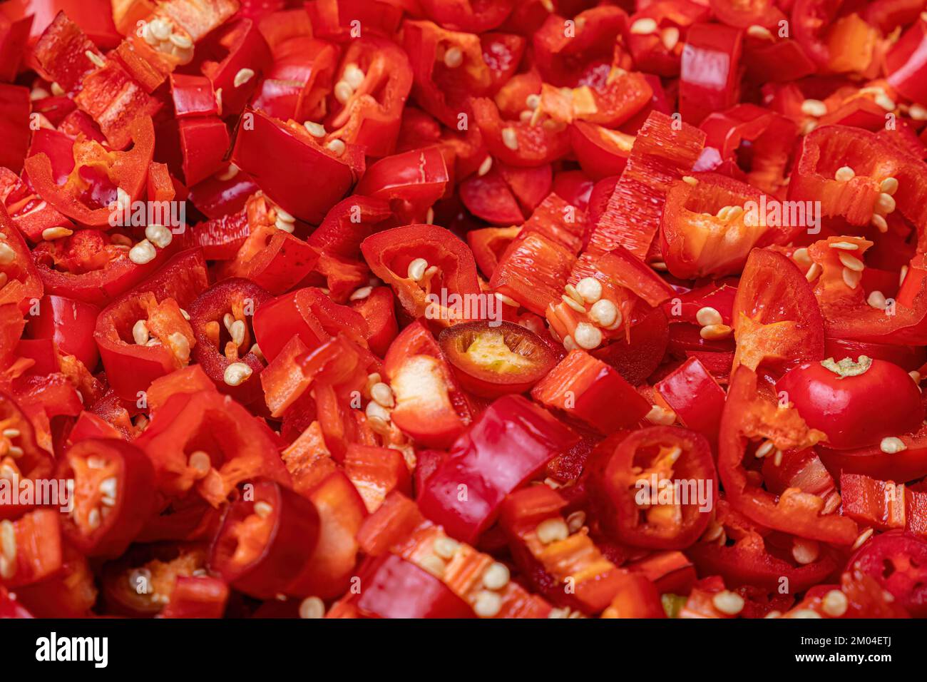 Many chopped big red peppers Stock Photo - Alamy
