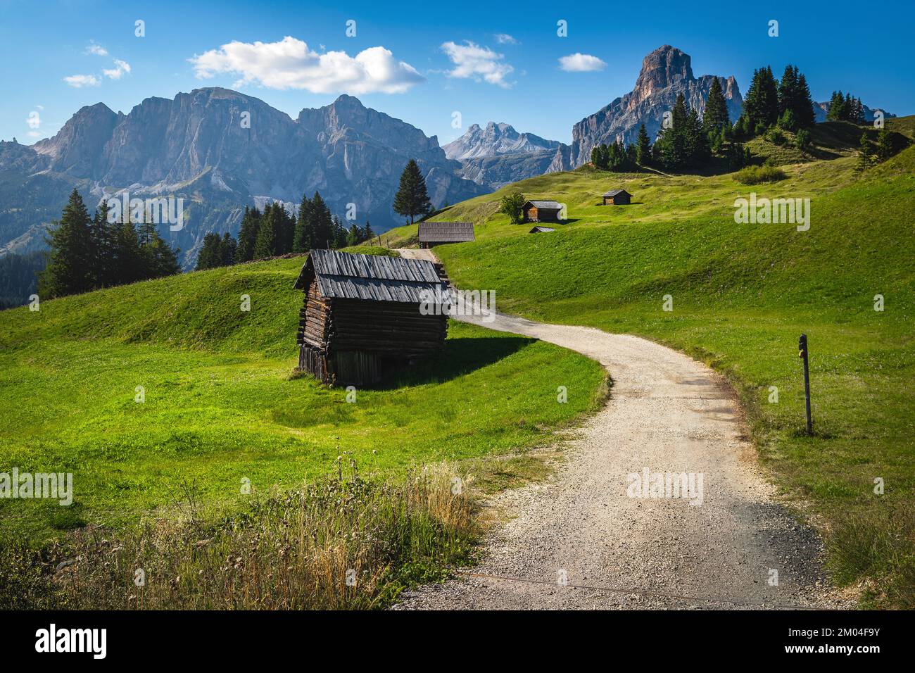 Famous Val Badia valley with wooden huts and stunning green fields ...