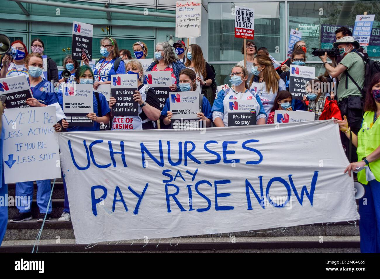 London, UK. 03rd July, 2021. Protesters hold placards and a banner ...