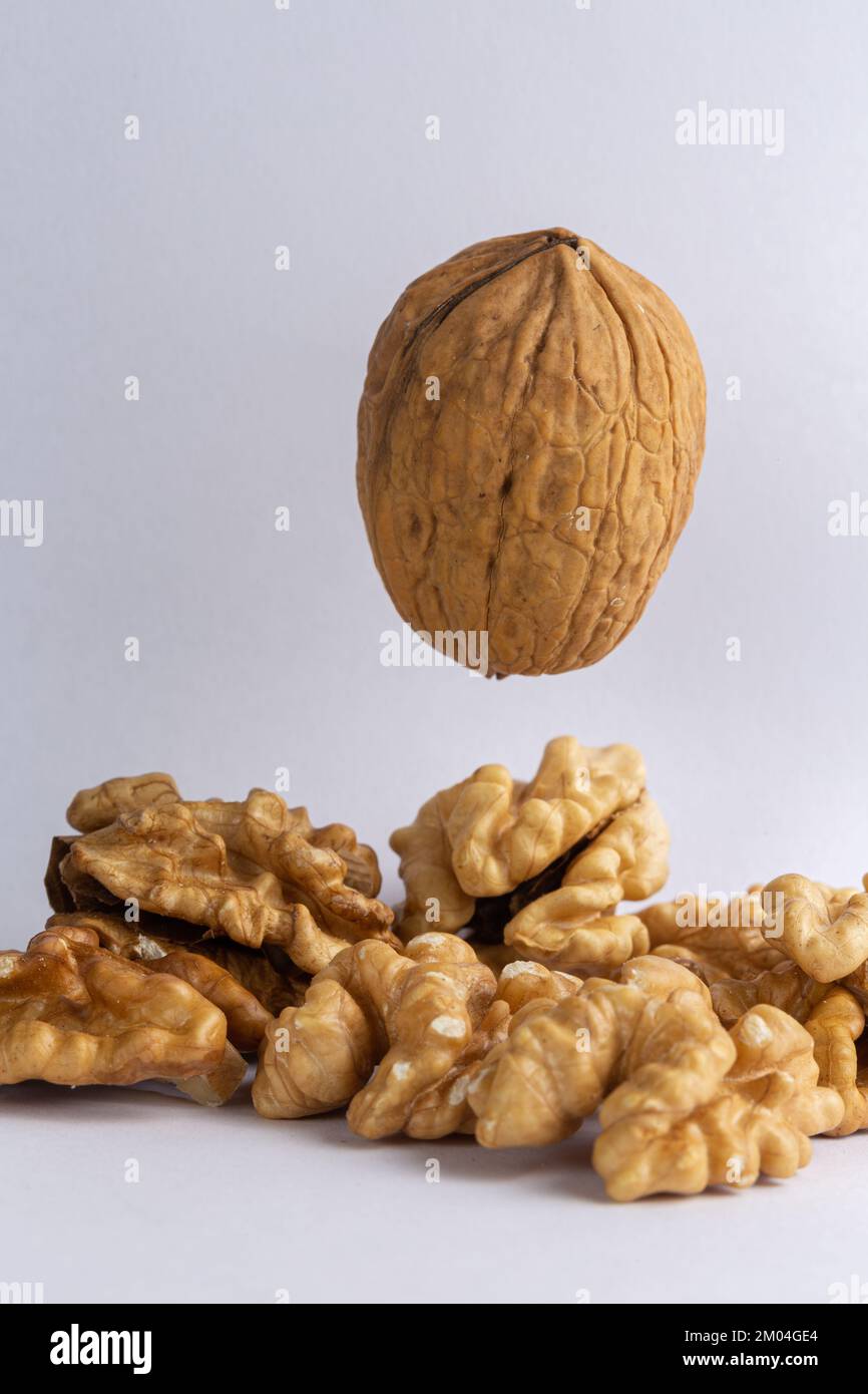 walnuts suspended in the air on a white background Stock Photo - Alamy