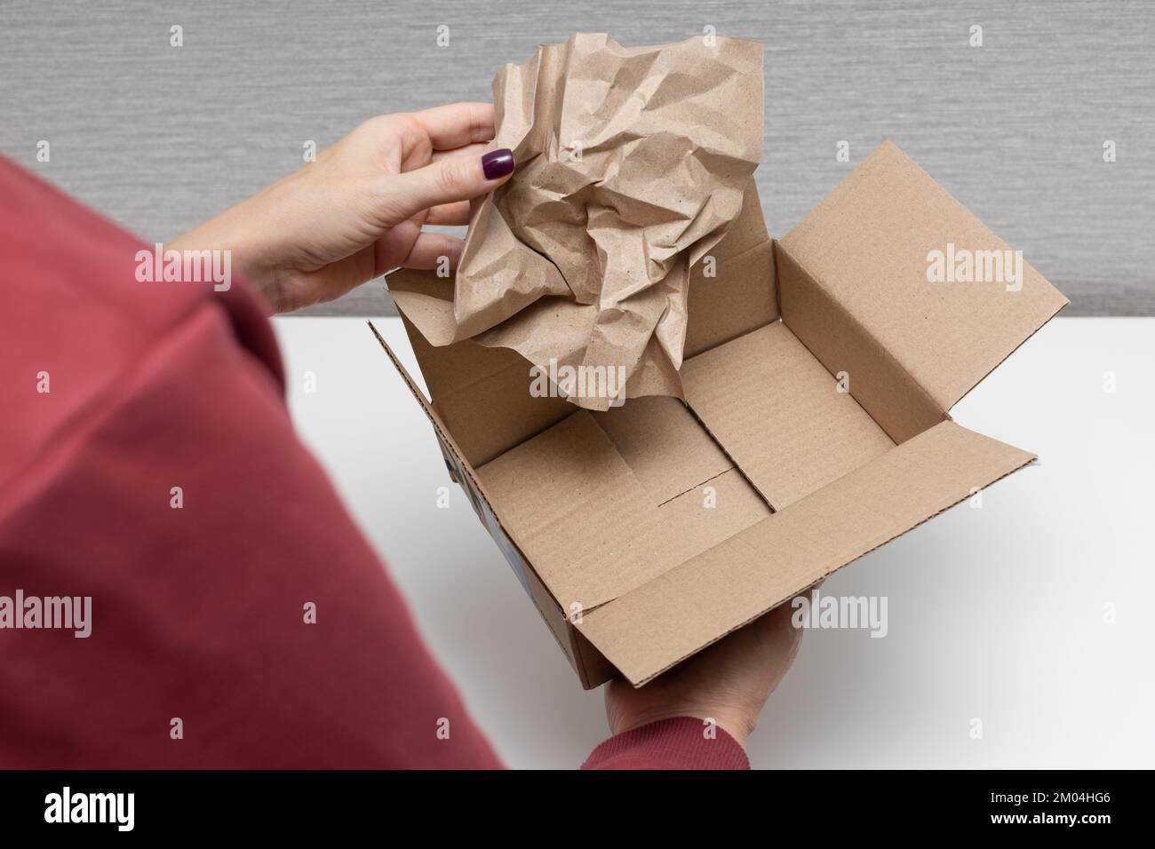 man holding an empty cardboard box, empty box Stock Photo - Alamy
