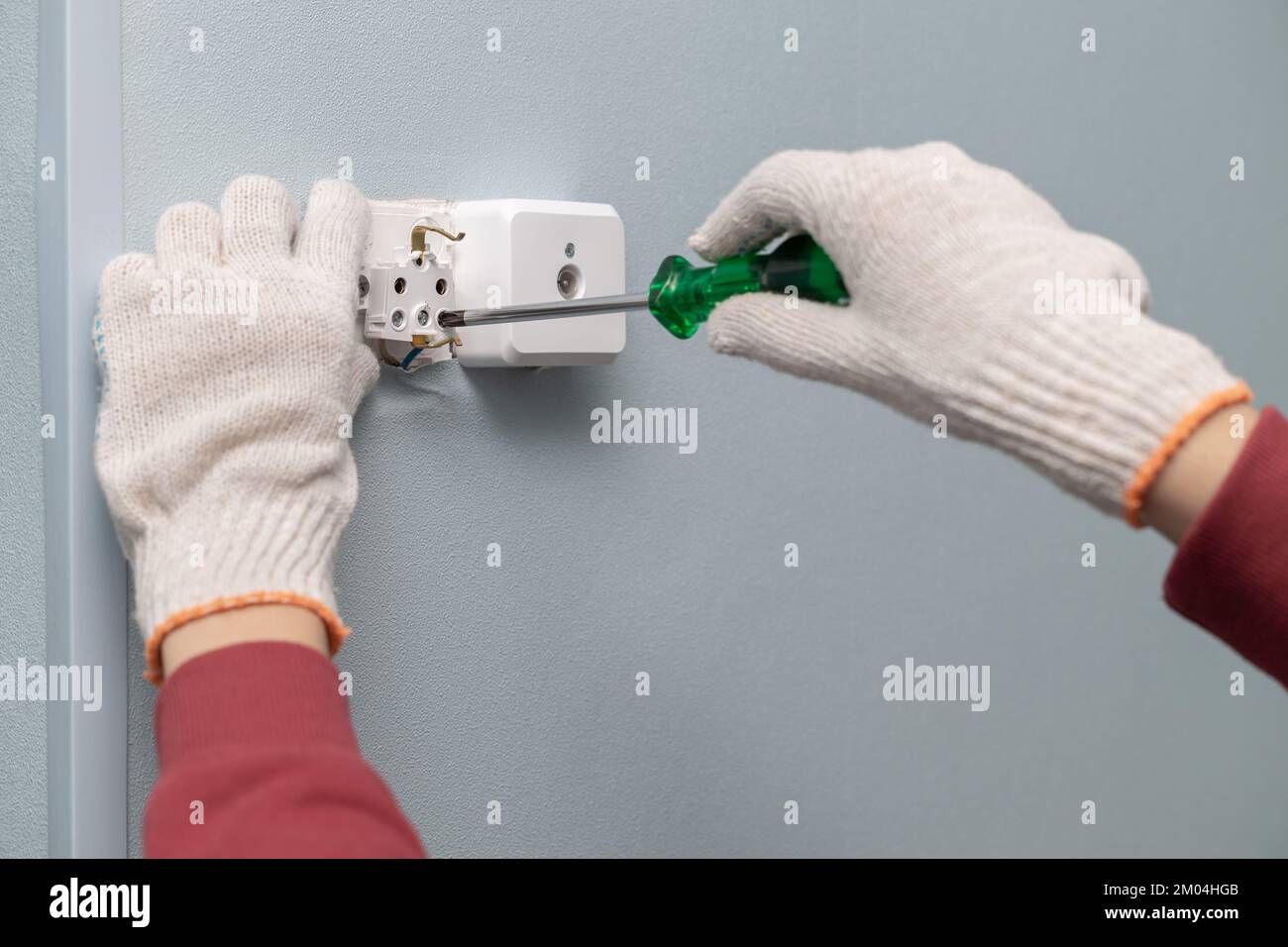 master repairing electrical outlet in the house Stock Photo - Alamy