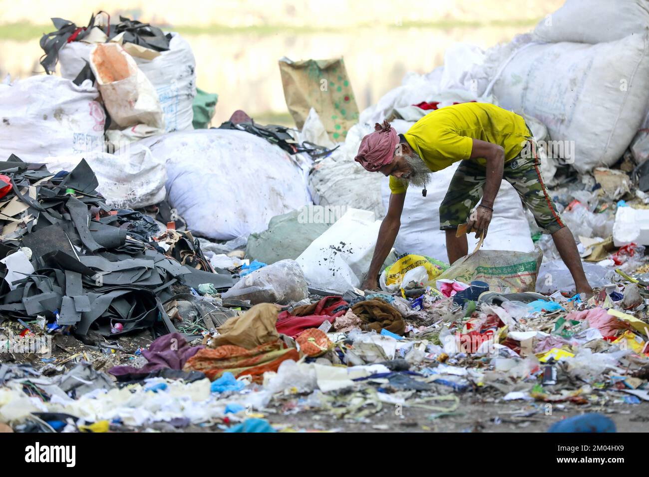 After collecting garbage from different places, a person is throwing it ...