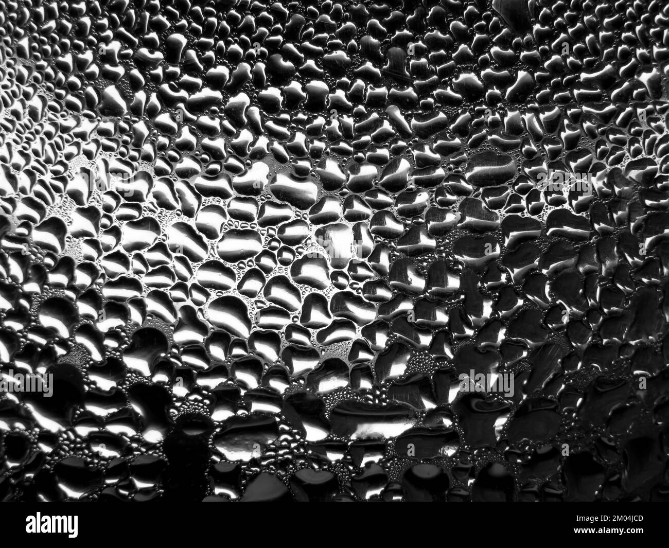 Glass with raindrops on dark tone background. Abstract wet texture with ...