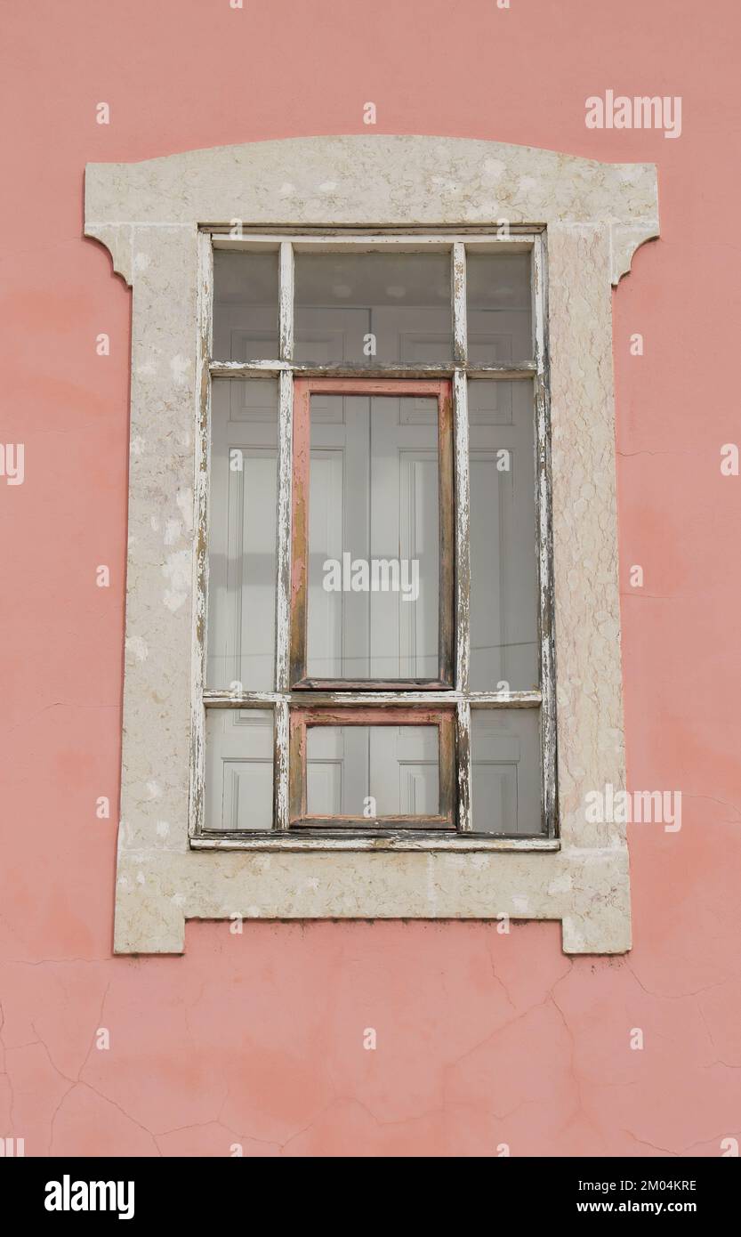 Beautiful pink portuguese facade with white window Stock Photo - Alamy