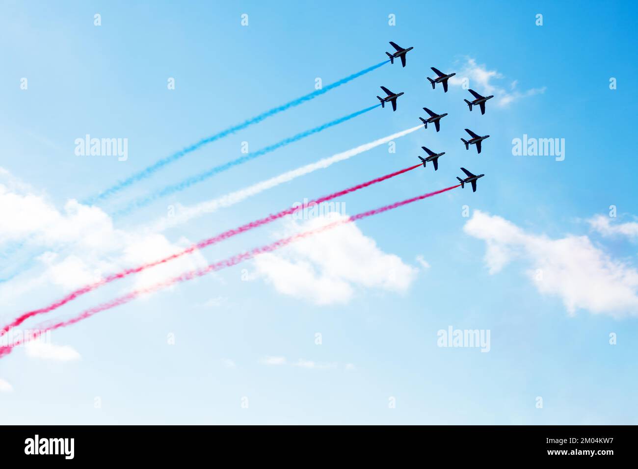 Group of planes fly with color trail in blue red white Stock Photo - Alamy
