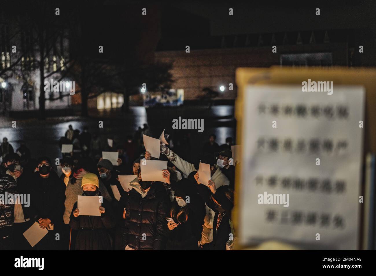 Protesters hold blank papers and lit candles during the demonstration ...