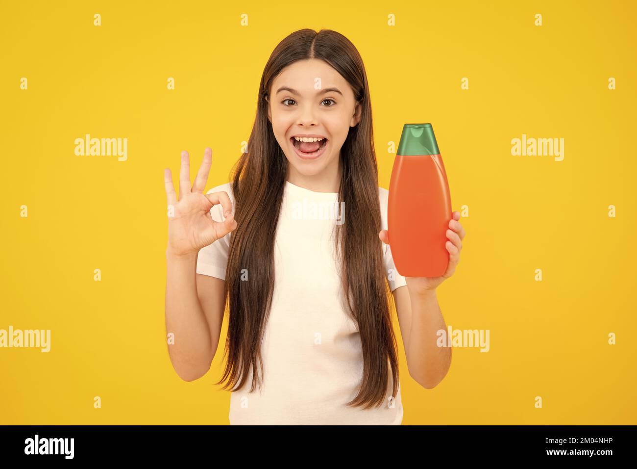 Teenager child girl with bottle shampoo conditioners or shower gel ...