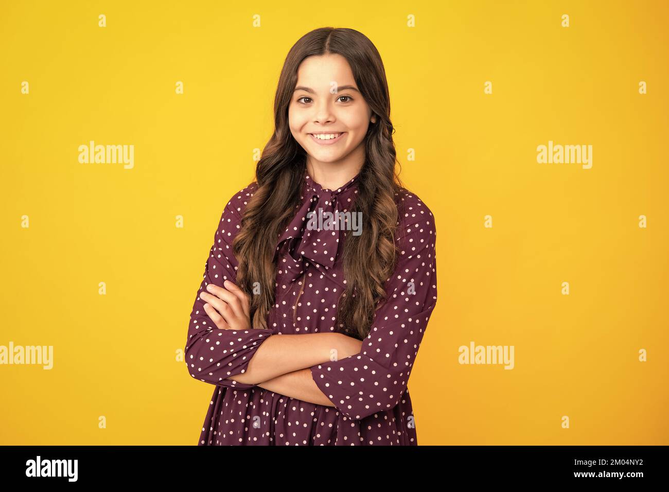 Cute little teenager girl crossing arms over yellow background Stock ...