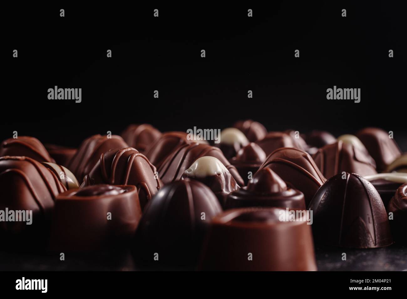 A lot of different chocolates. An assortment of delicious chocolates in ...