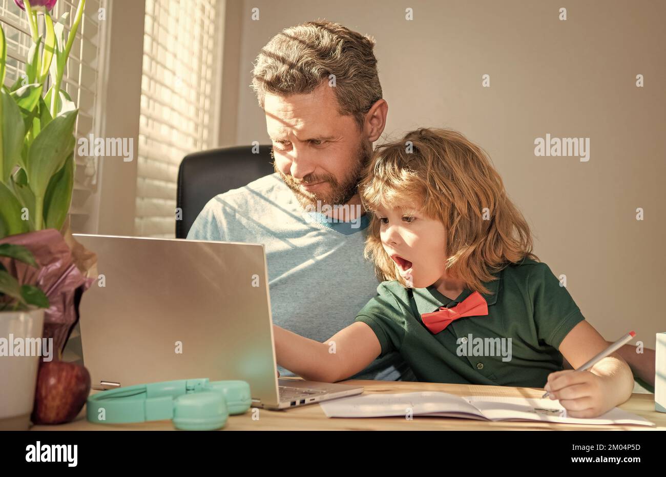 mature man teacher or dad helping kid son with school homework on ...