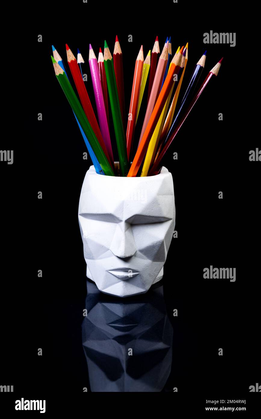 Color pencils for the drawing, located in a support as a vase, focus in ...