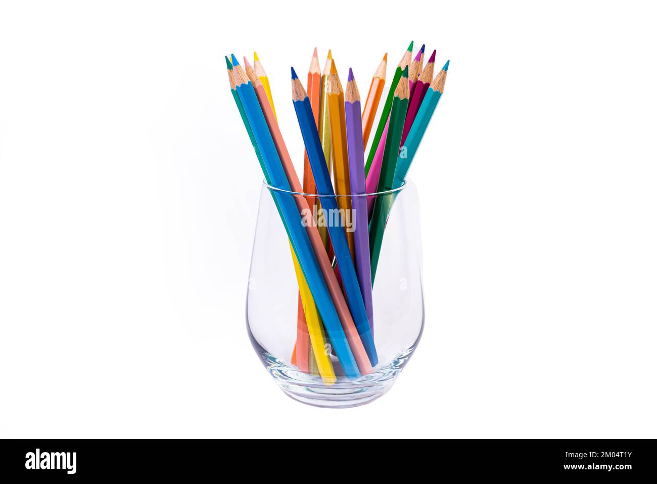 multi-colored pencils in a wine glass and a bucket. Selective blurred a ...