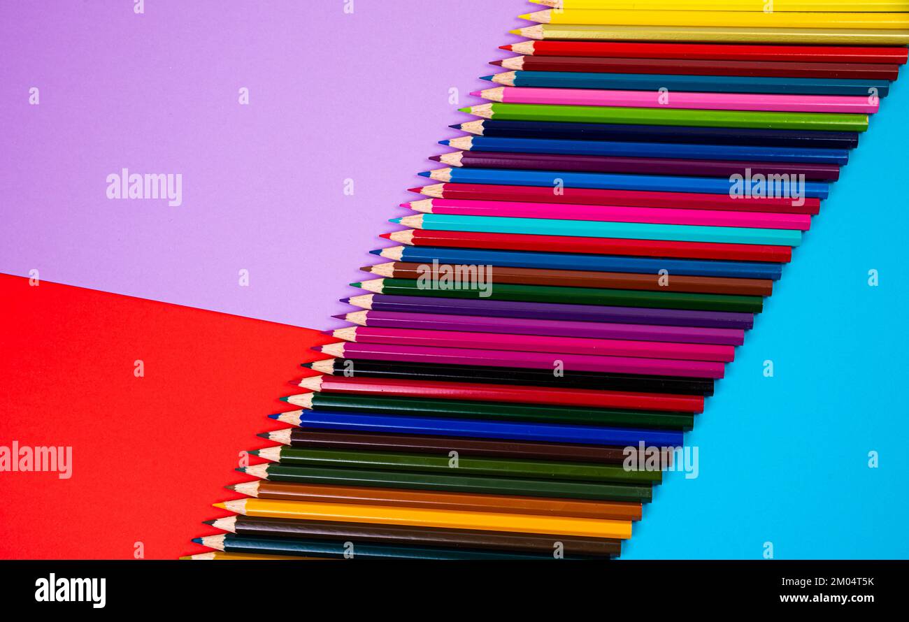 multi-colored pencils on multi-colored background, Close up, copy space ...