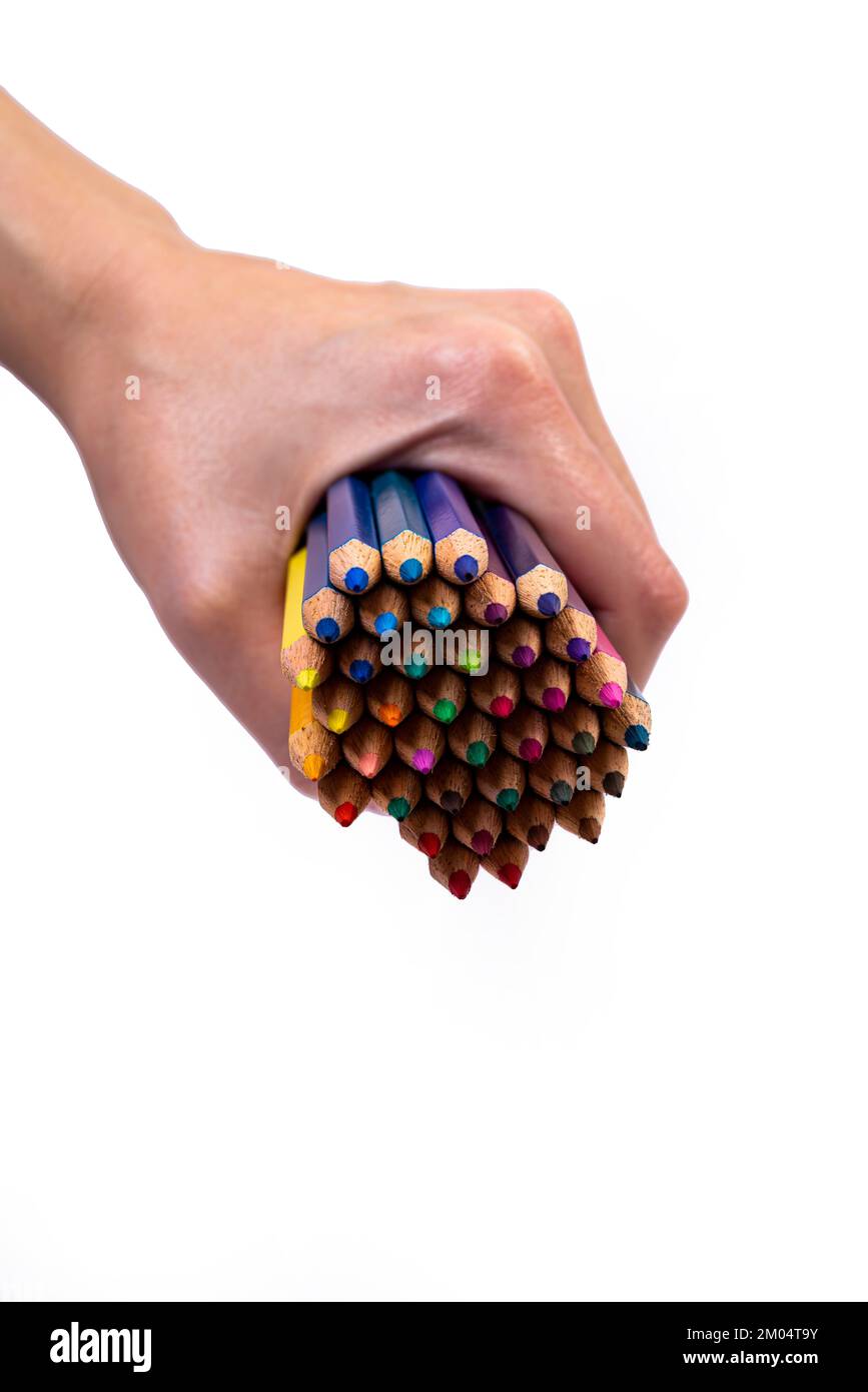 Multi-colored pencils for drawing in a female hand. multi-colored ...