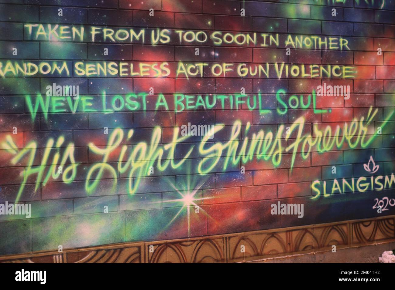 A tribute mural to Brandon McGhee spray painted on an inner city ...