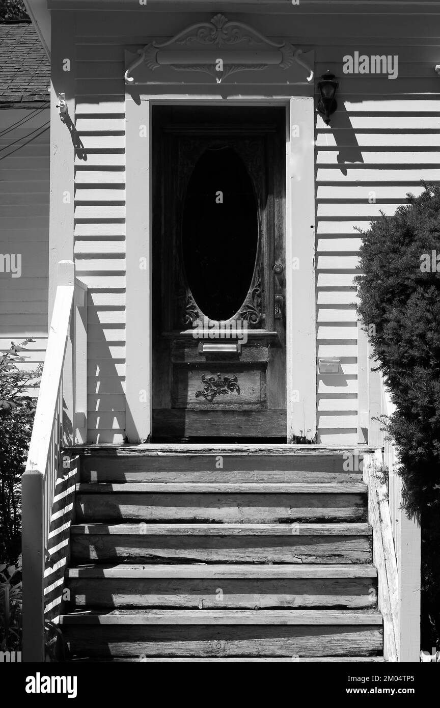 Typical wooden stairs leading up to a colonial home in a black and ...